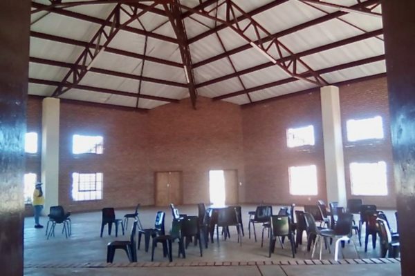 Bad roads and no tap water but there's a multi-million community hall